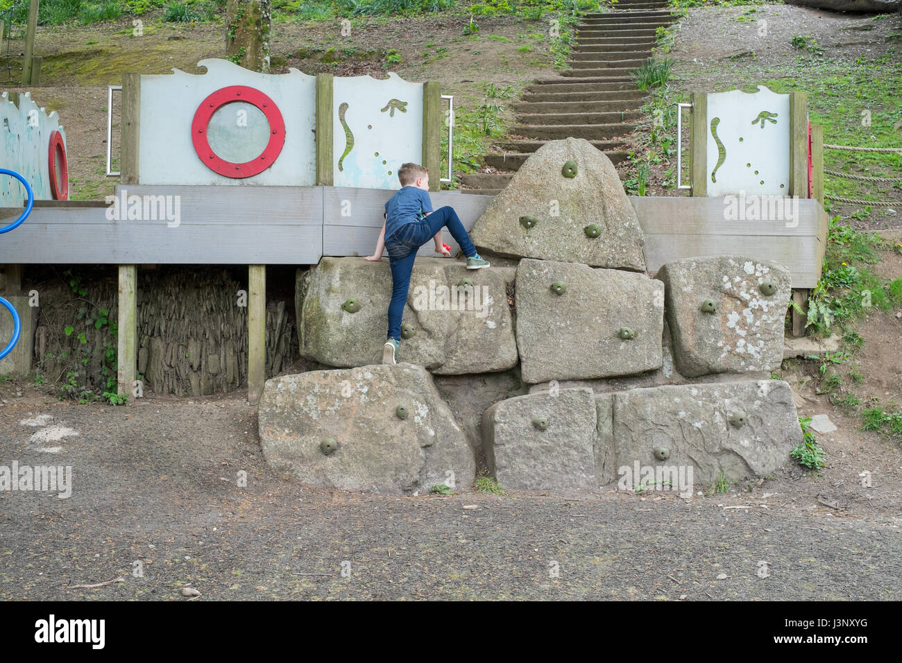 Seven year old boy playing at the park recreation ground, Kingsbridge ...