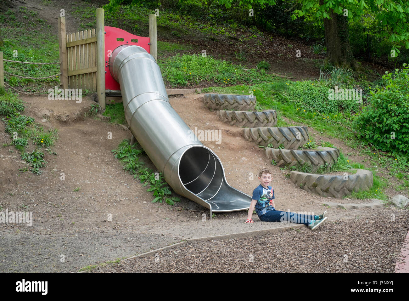 Seven year old boy playing at the park recreation ground, Kingsbridge ...