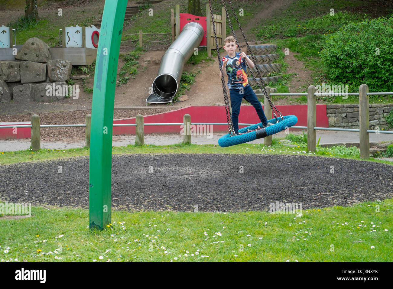 Seven year old boy playing at the park recreation ground, Kingsbridge ...
