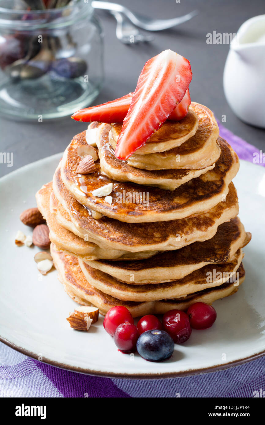 Stack of pancakes with fresh fruits and honey. Closeup view, vertical ...