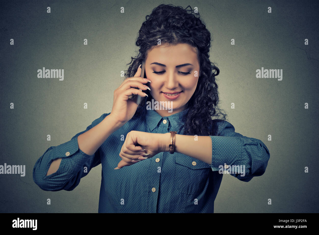 Business and time management concept. Happy business woman looking at ...