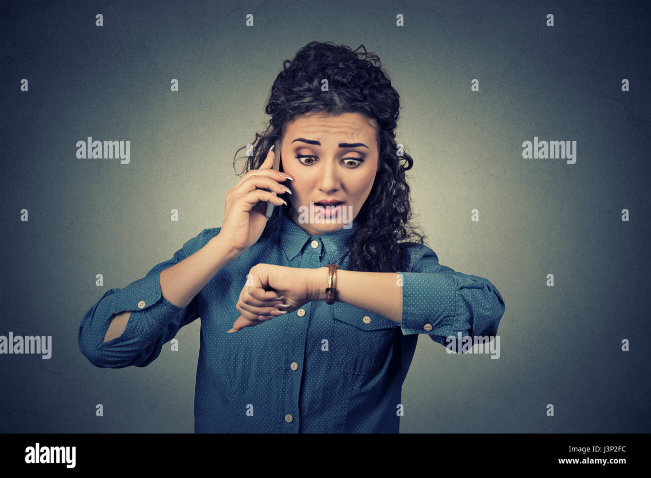 Business and time management concept. Stressed businesswoman looking at ...