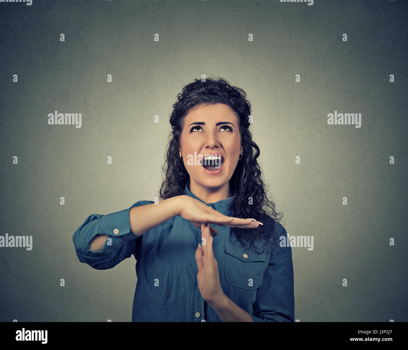 Young woman showing time out hand gesture, frustrated screaming to stop ...