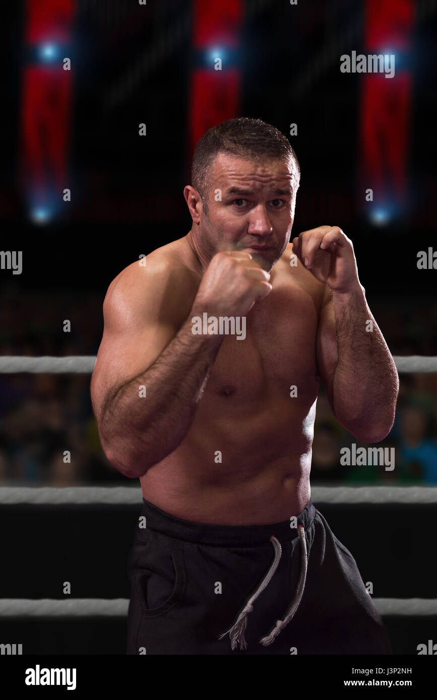 professional kickboxer with hands in martial arts position training for ...