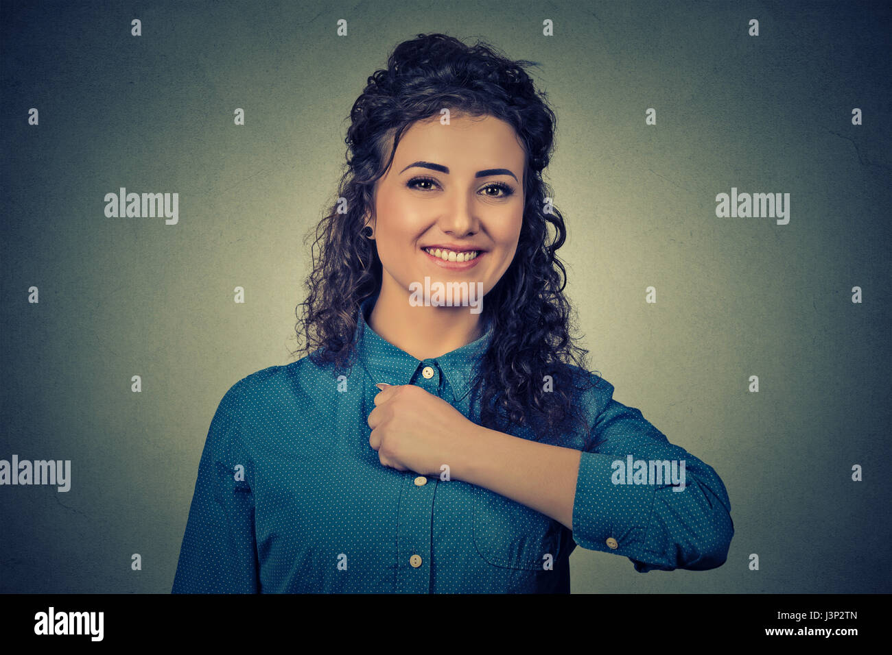 Superhero girl. Confident brave happy young woman isolated on gray wall ...