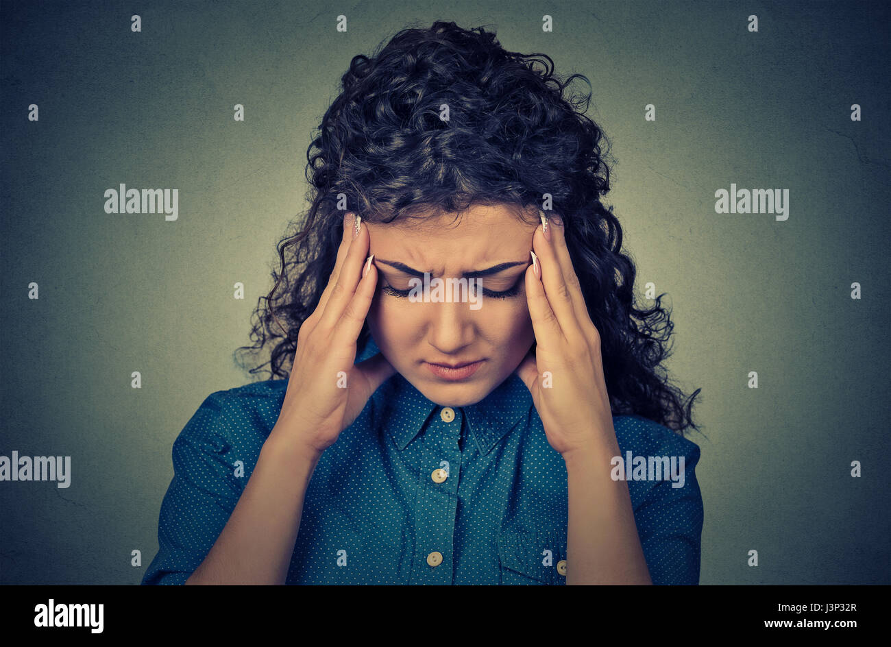 Closeup portrait worried sad young looking down isolated on gray wall ...
