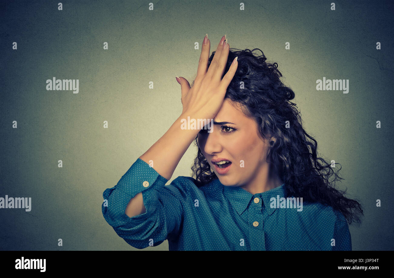 Regrets wrong doing. Closeup portrait silly young woman, slapping hand ...