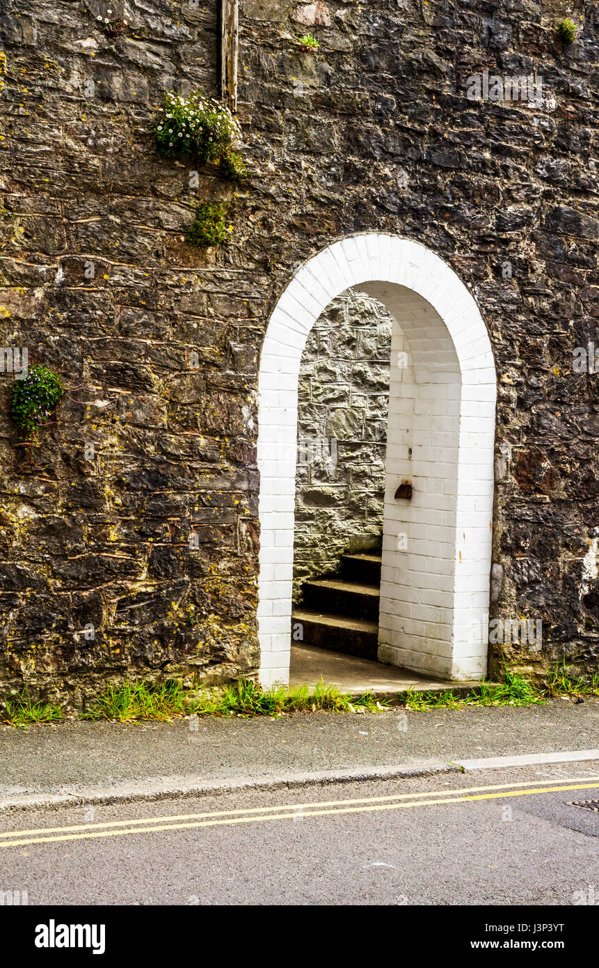 open wooden door with pointed gothic arch on a white stone wall , wall ...