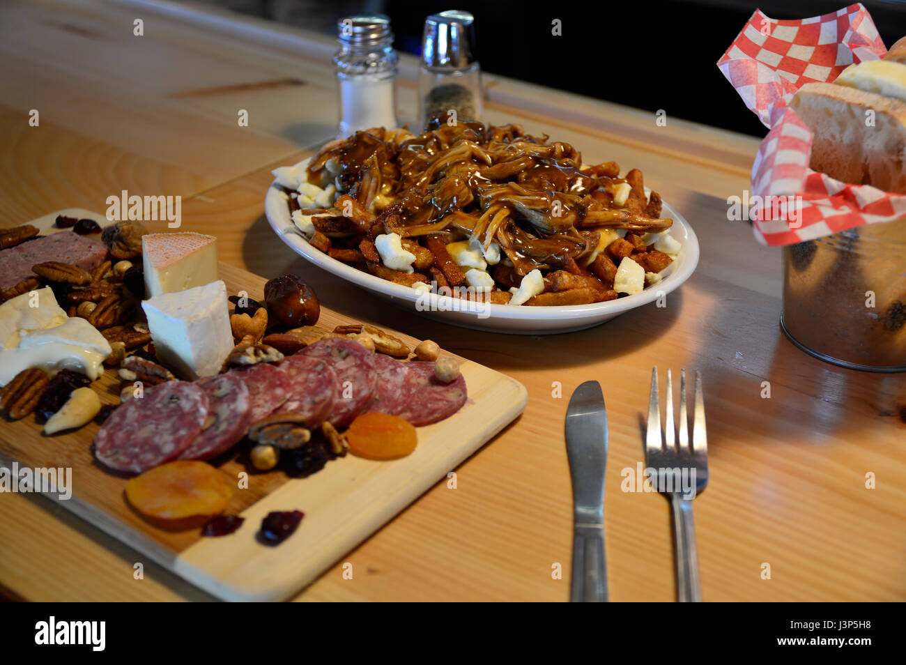 typical Quebec meal, french fries, cheese curds melted in a hot brown ...