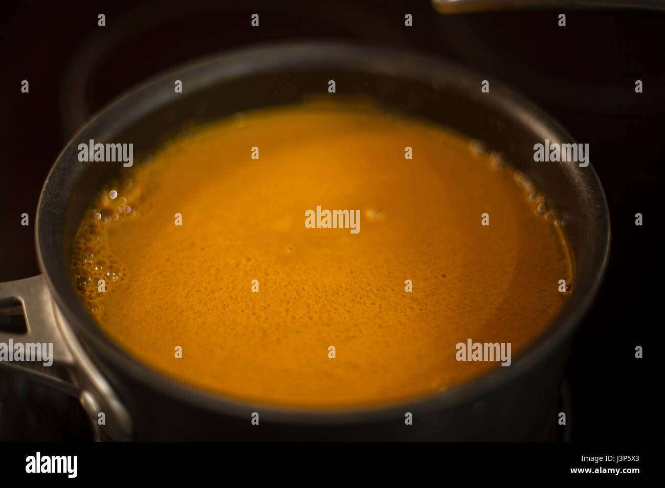 Boiling Turmeric to Extract Natural Food Color Stock Photo - Alamy