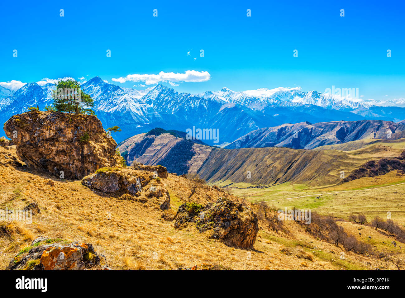 beautiful landscape of Caucasus mountains with clouds and blue sky ...