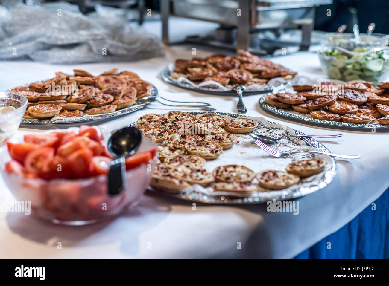 Stack of mini Pizza on plates at the buffet during a business meeting ...