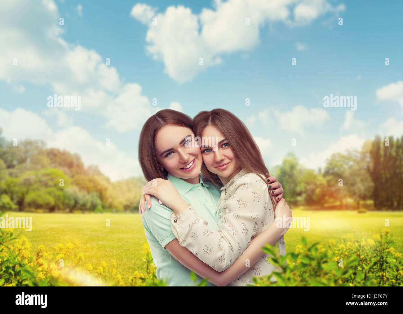 Two girlfriends hugs together, nature landscape on background. Female ...