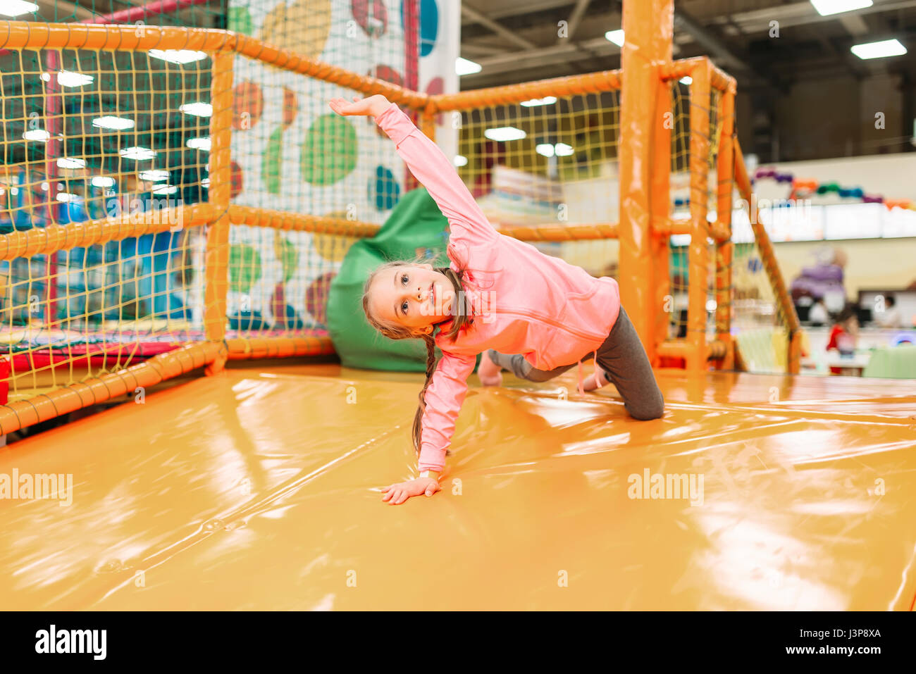 Cute girl having fun on inflatable attraction in childrens ...