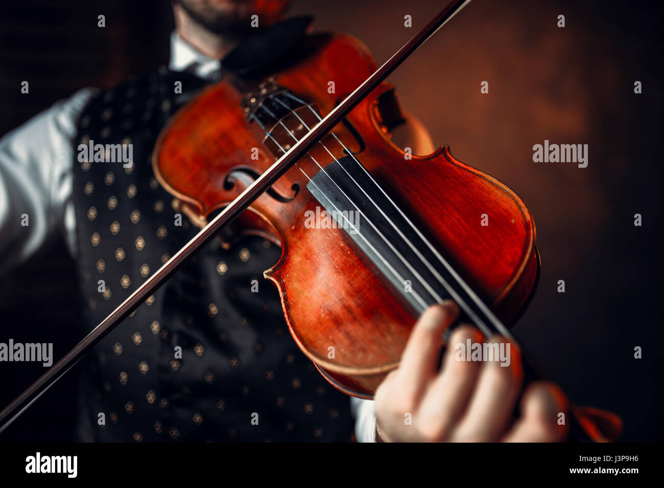 Male violinist playing classical music on violin. Fiddler man with ...