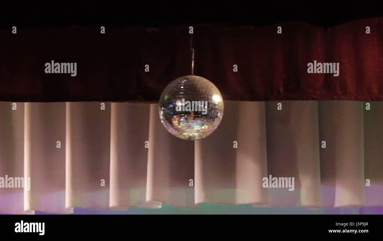 Mirror ball reflects white light. Disco ball with reflected moving rays ...