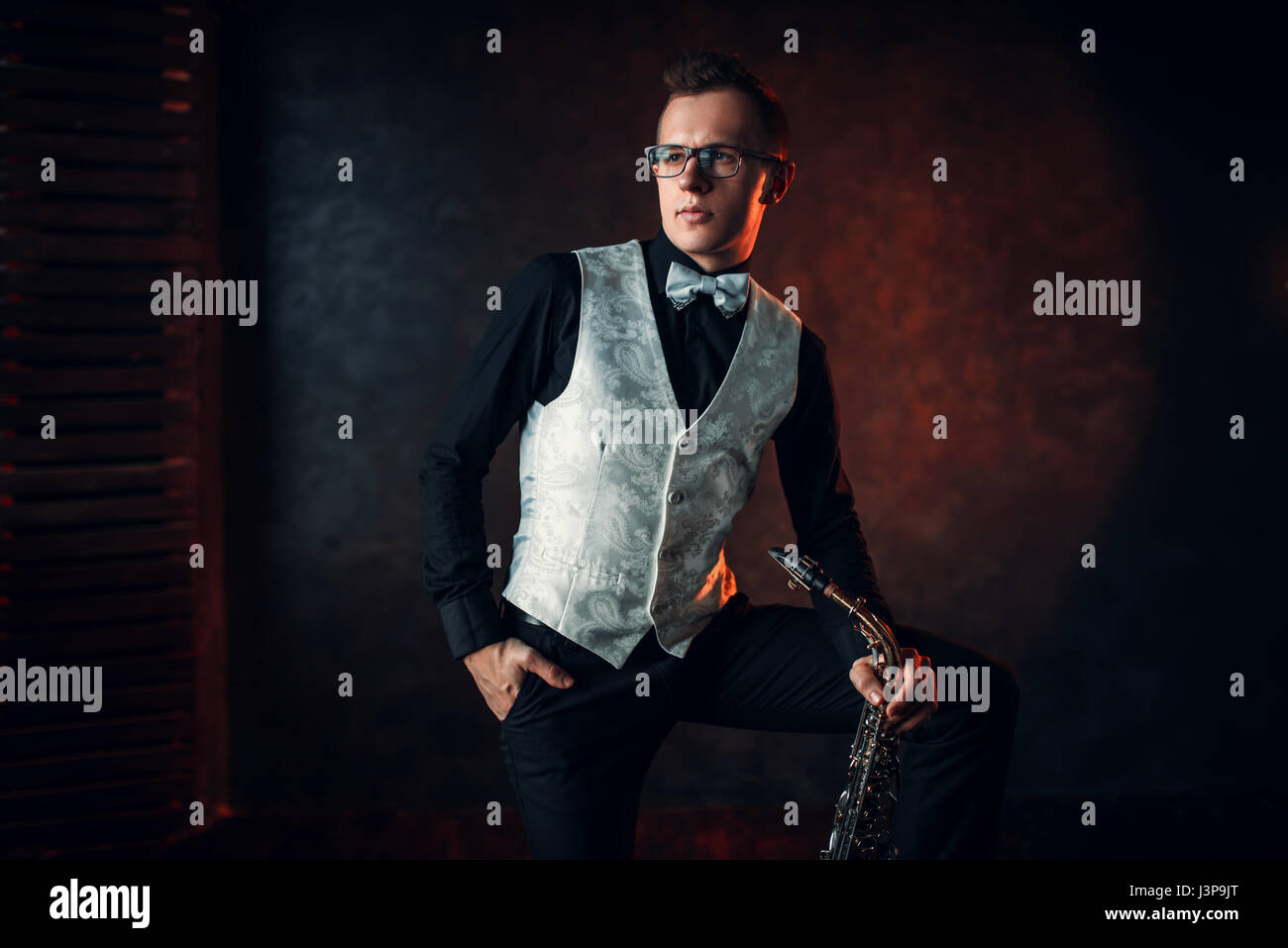 Portrait of male saxophonist with saxophone, jazz man with sax ...