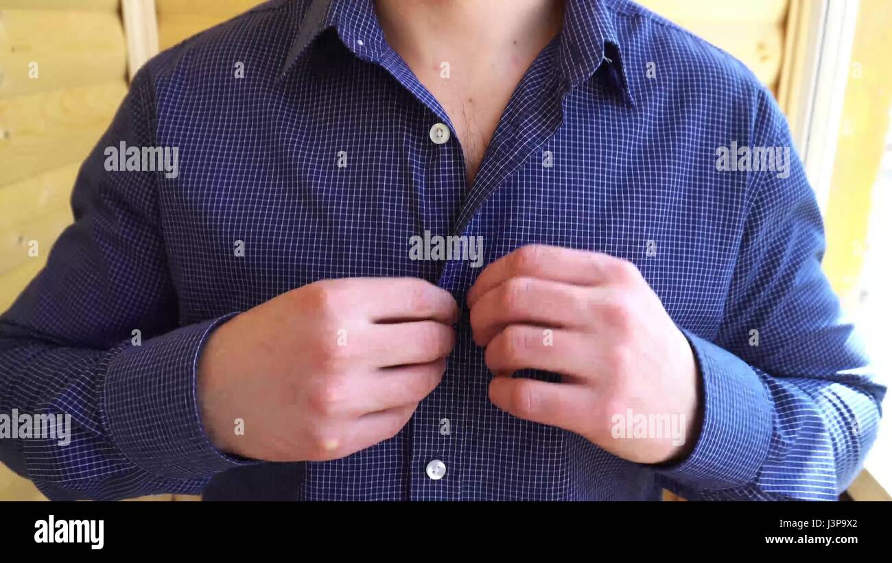 the young man unbuttoned blue shirt Stock Photo - Alamy