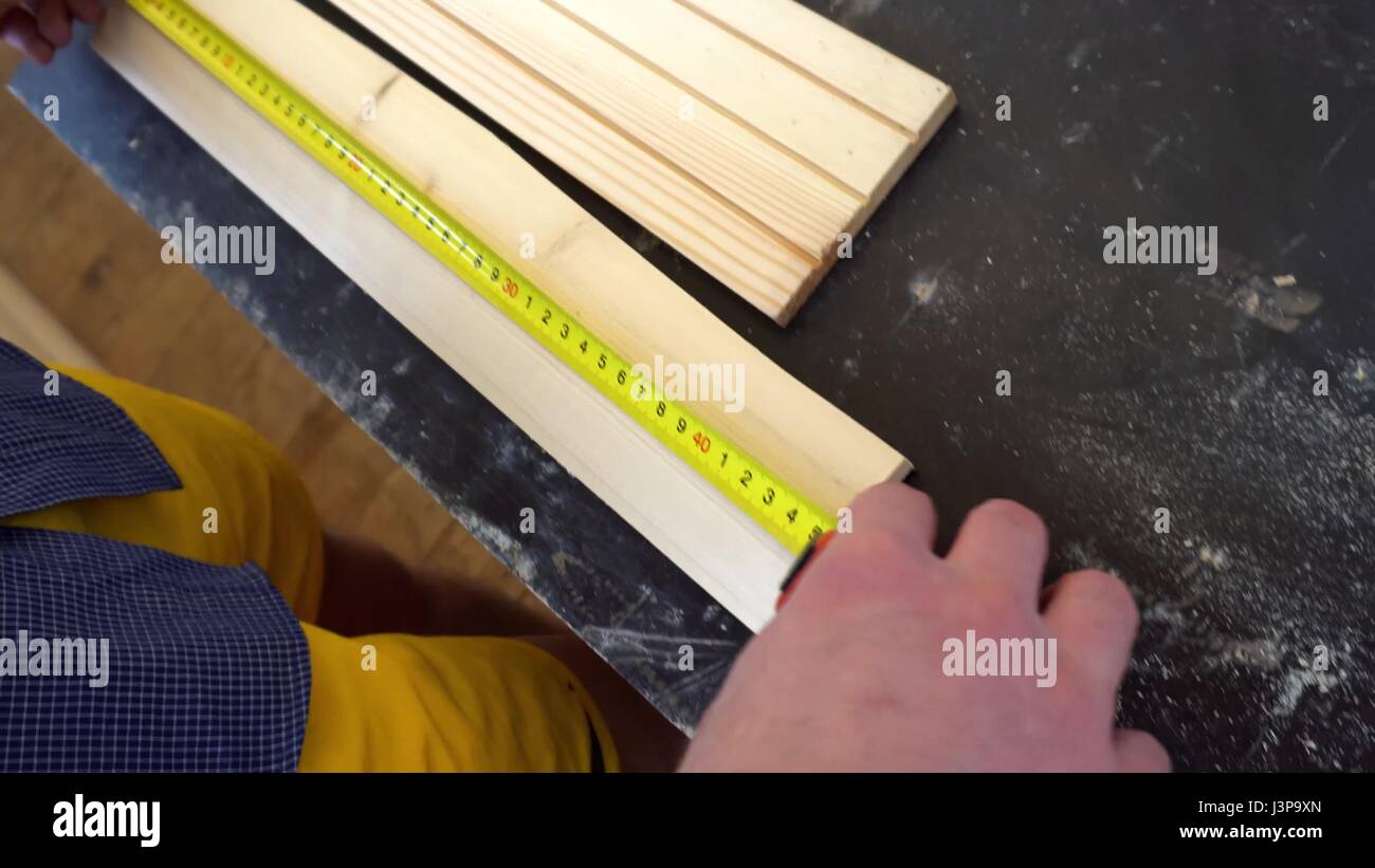 the carpenter measures a piece of Board Stock Photo - Alamy