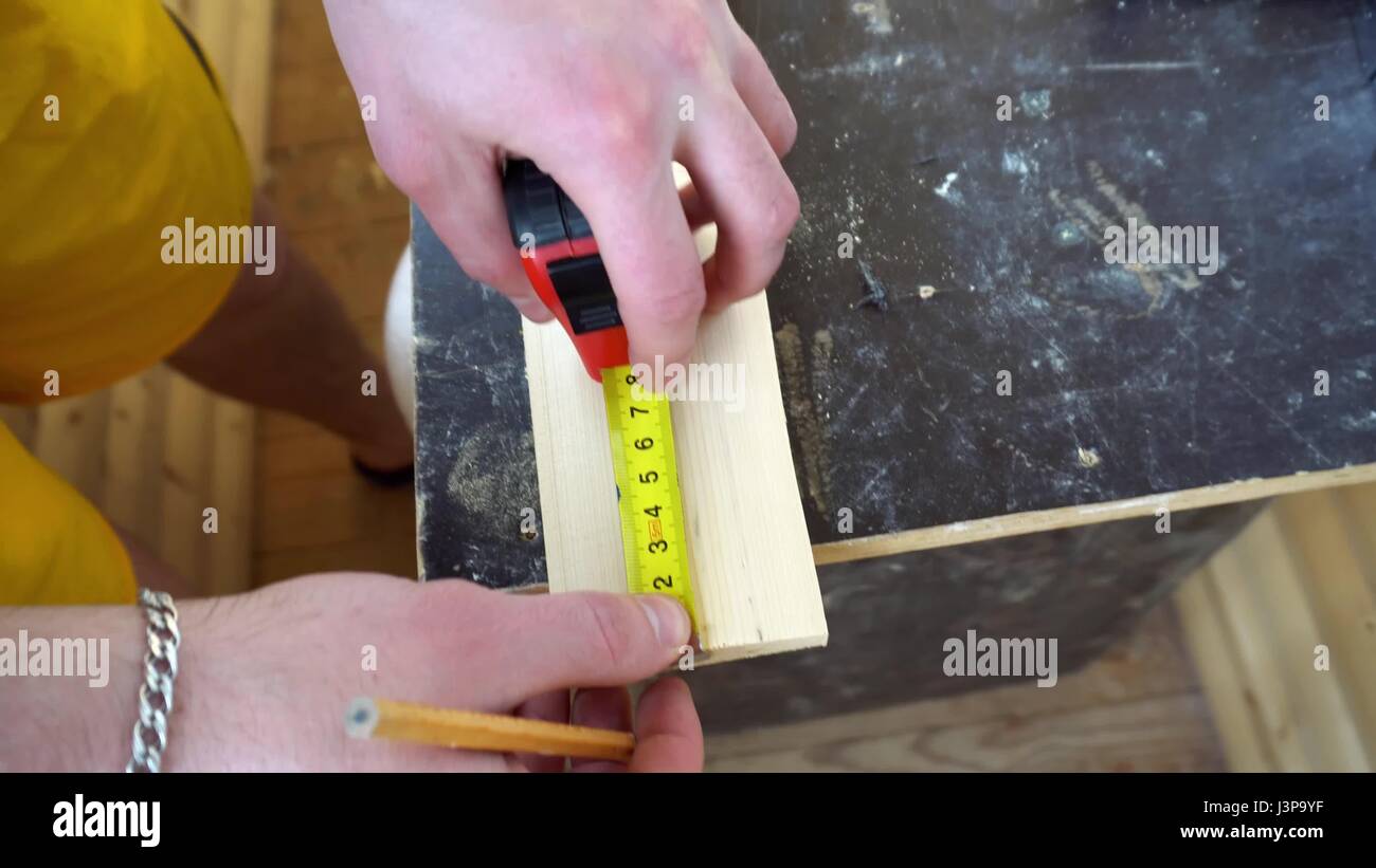 the carpenter measures a piece of Board Stock Photo - Alamy