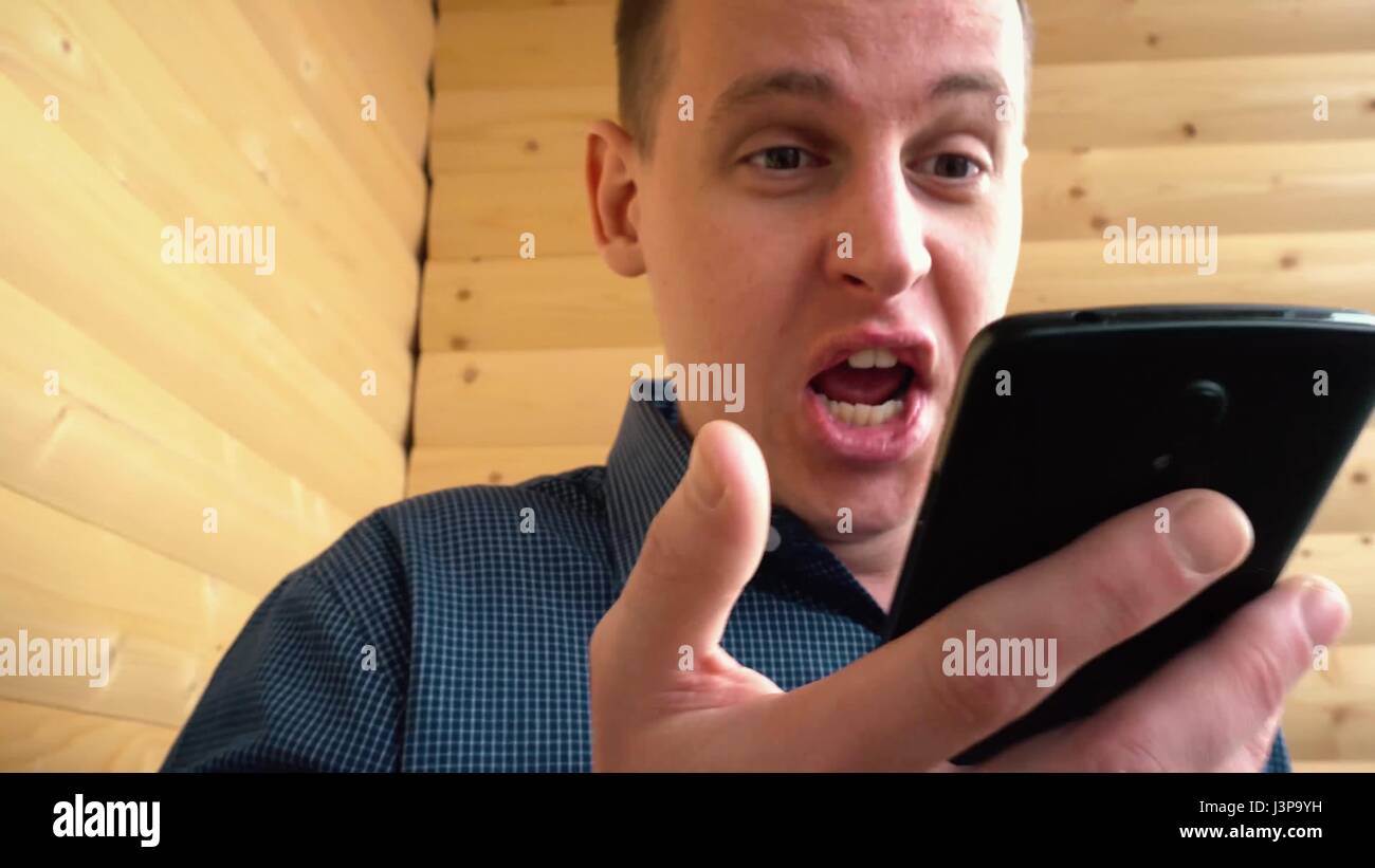 Frustrated man yelling at his smartphone Stock Photo - Alamy