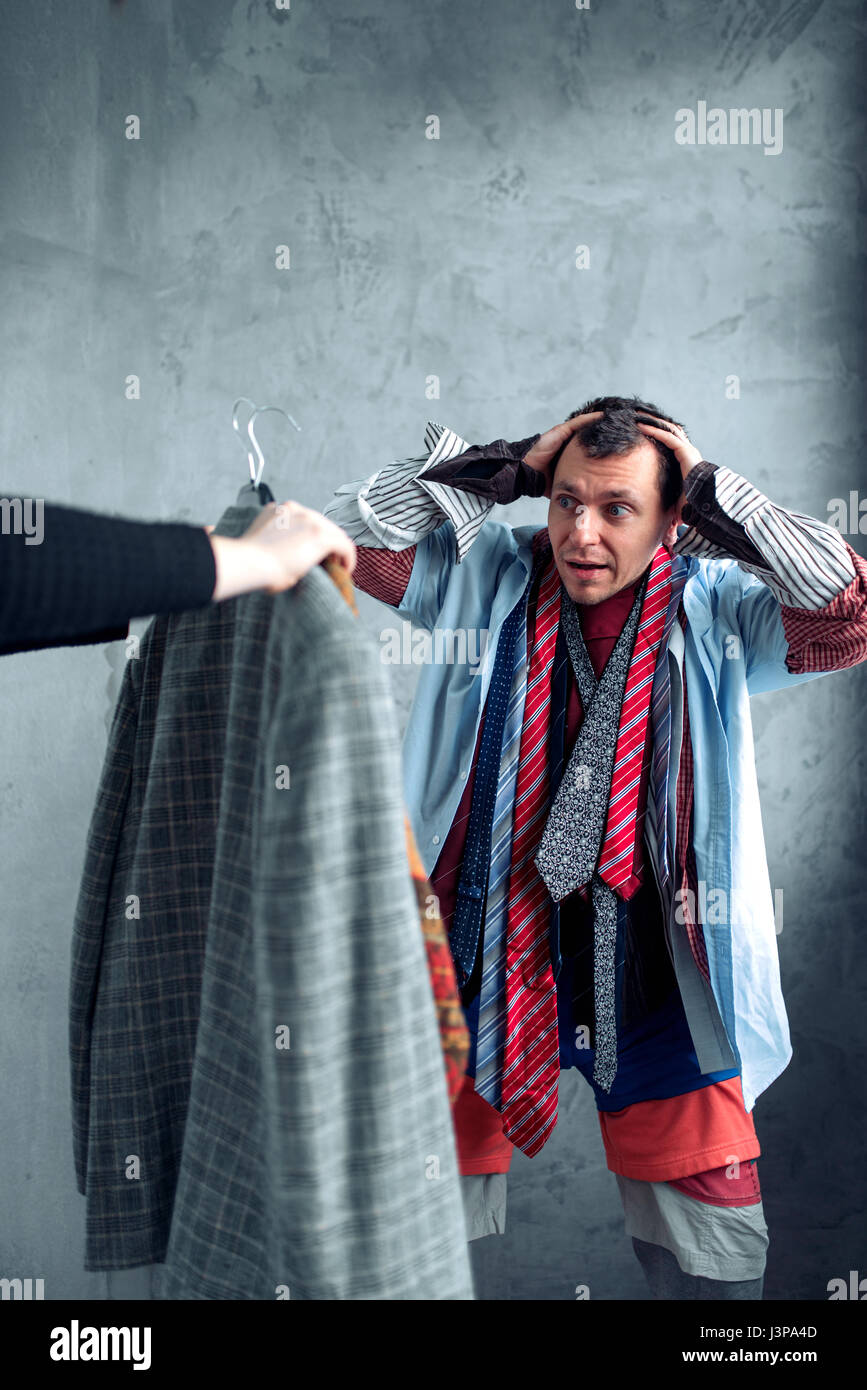 Man can not choose the clothes at the shop. Problem with choice ...