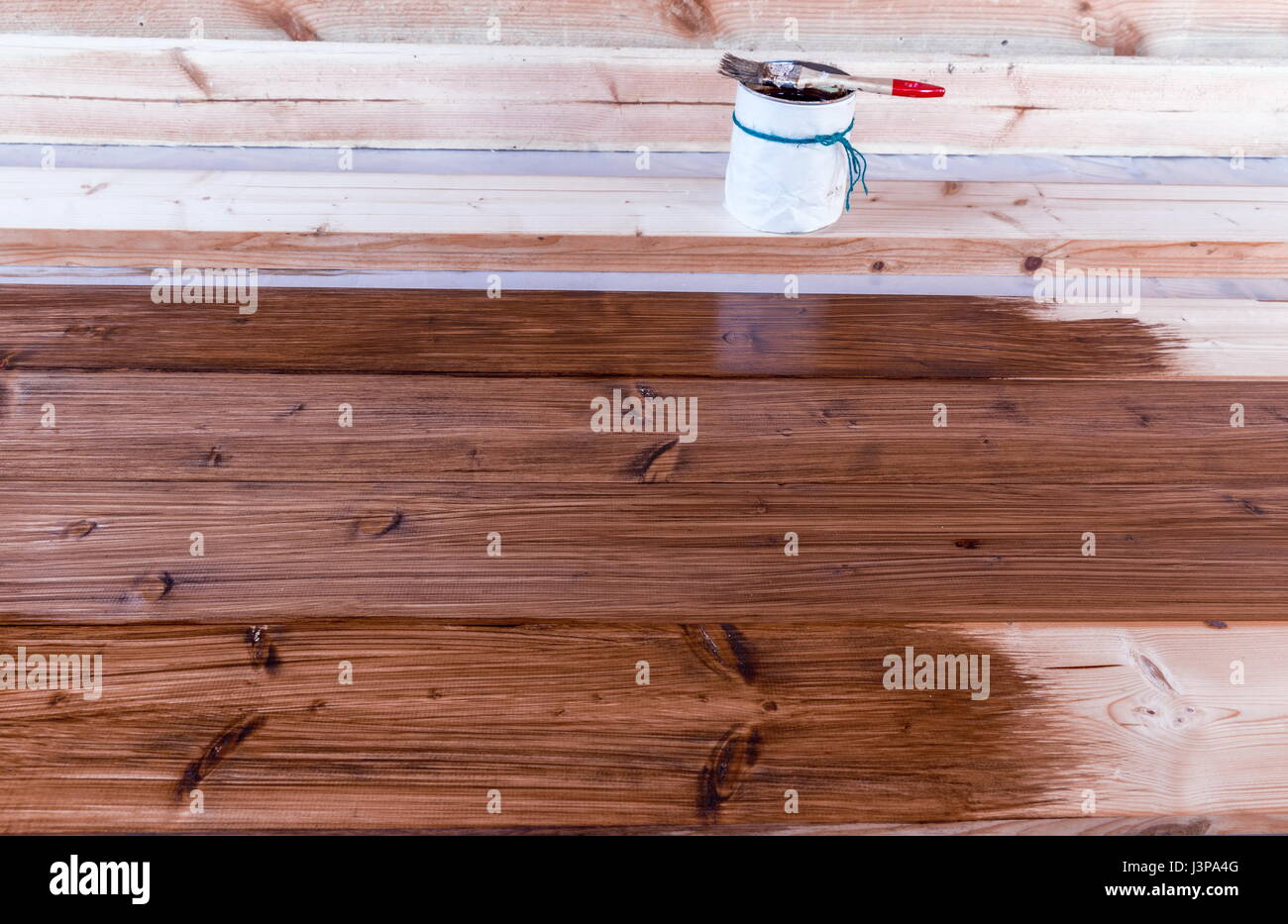 The process of painting wood surfaces with a brush. Unfinished painting ...