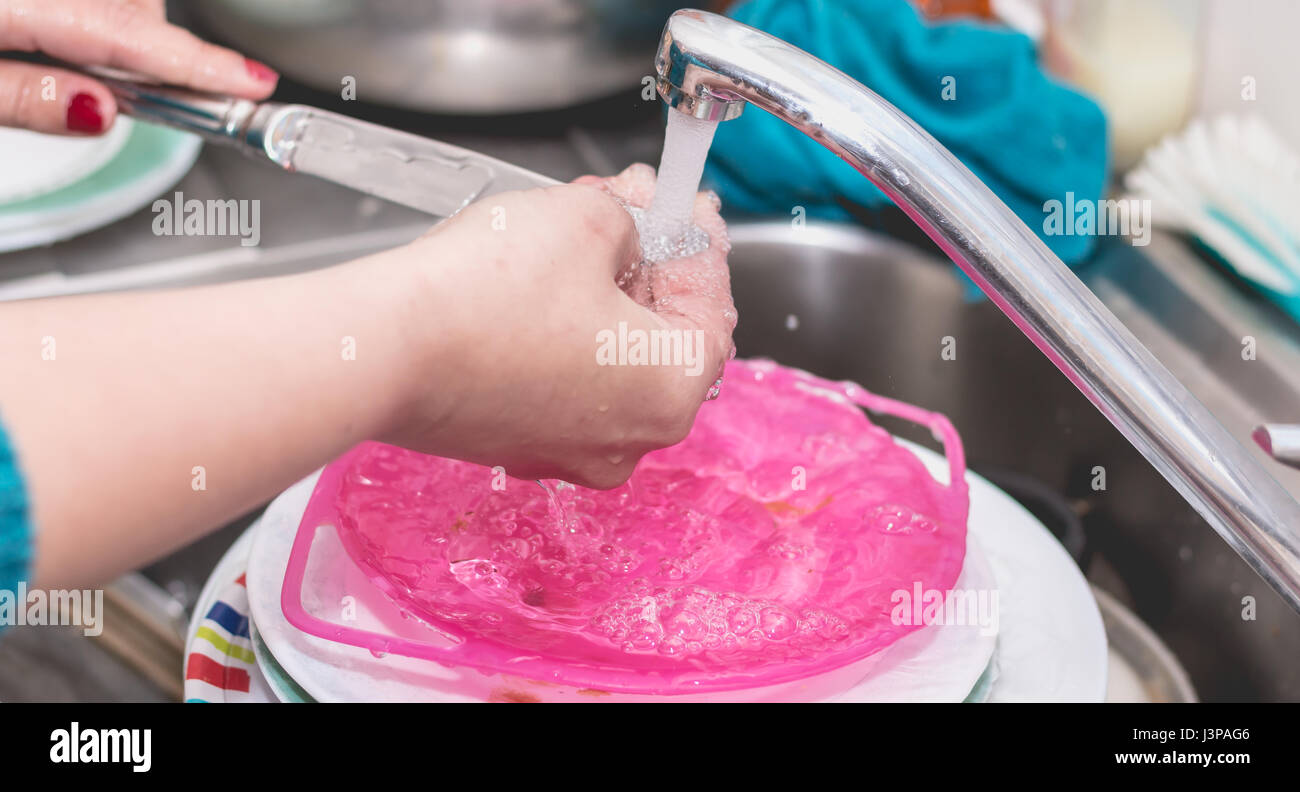 Close-up of the hand of a woman doing dishes Stock Photo - Alamy