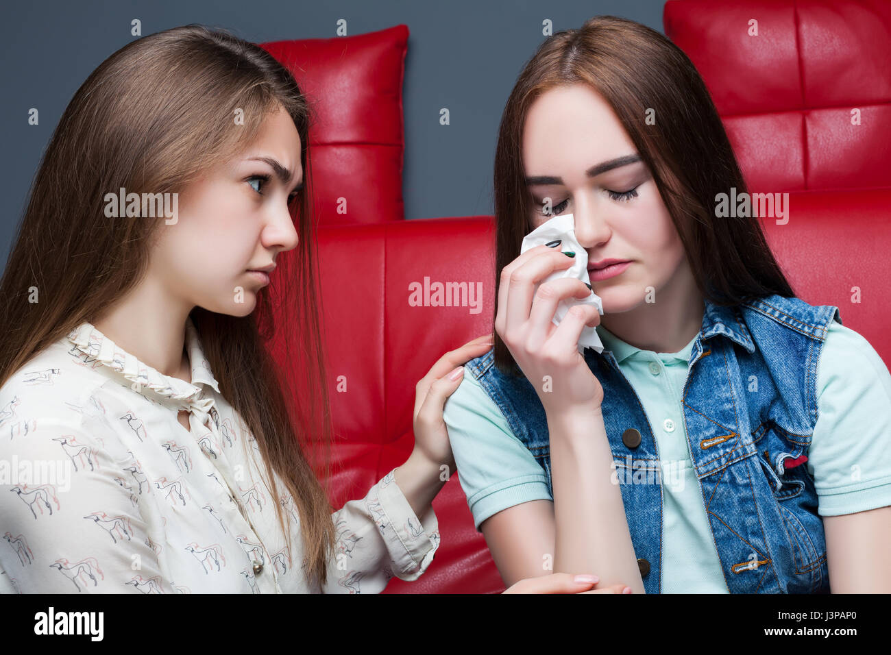 Girl calms her upset girlfriend, female friendship. Women secrets Stock ...