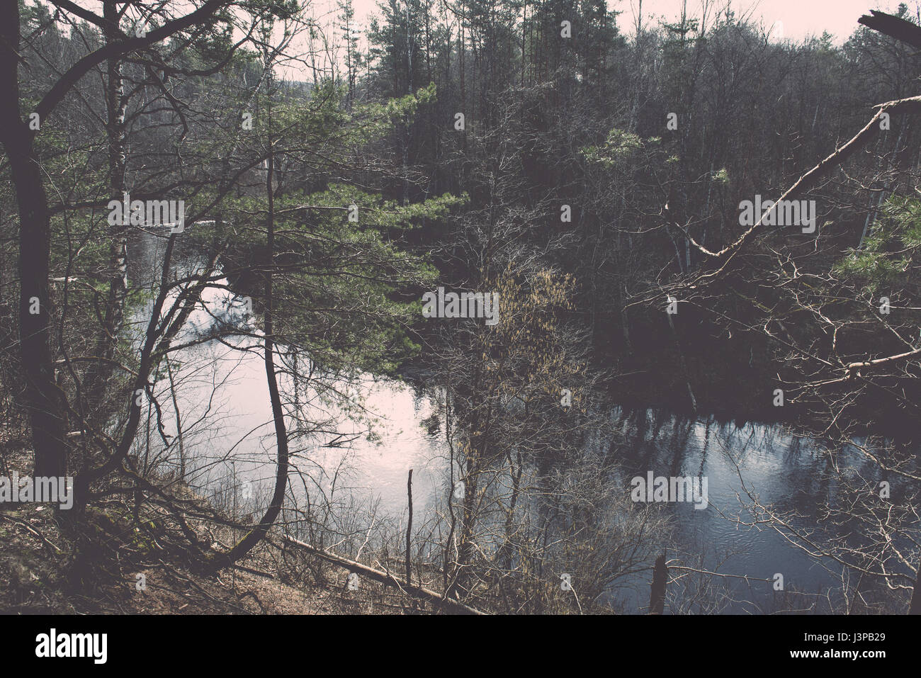 scenic spring colored river in country with trees and reflections ...