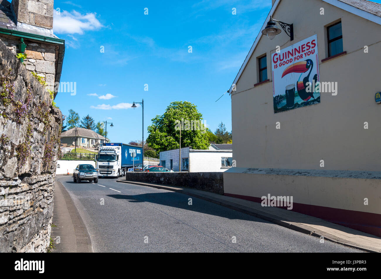 Traffic crossing the river bridge which marks the frontier at Pettigo ...