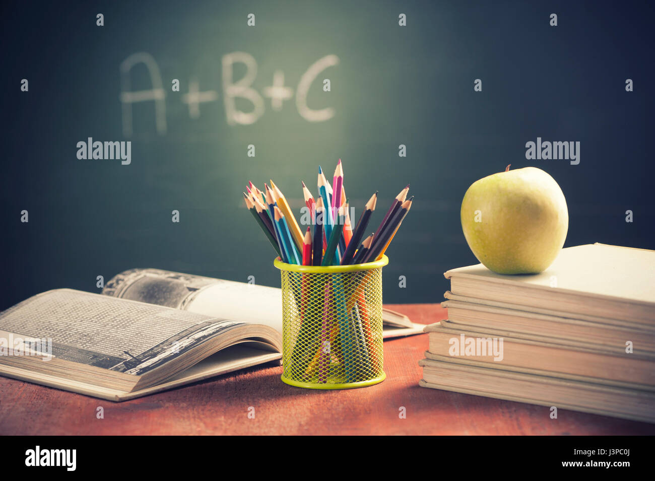 Stack of books in classroom Stock Photo - Alamy