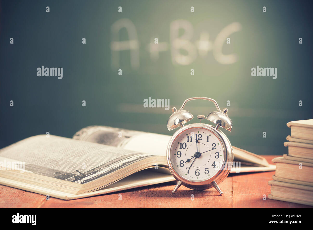 Stack of books in classroom Stock Photo - Alamy