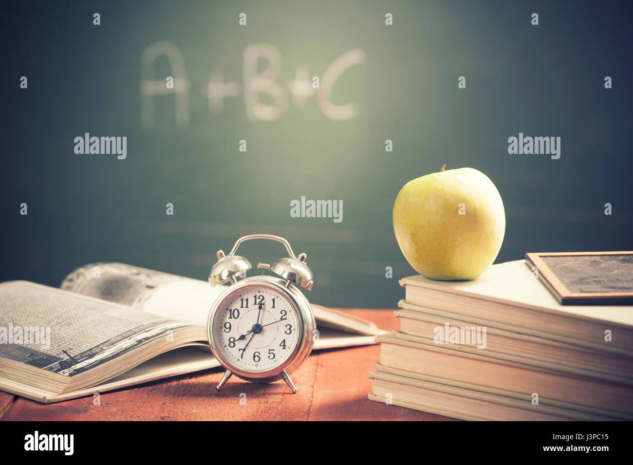 Stack of books in classroom Stock Photo - Alamy