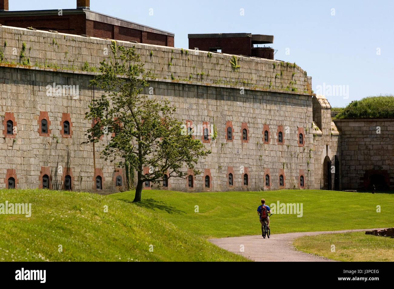 A biker passes by Fort Adams at Fort Adam State Park in Newport, Rhode ...
