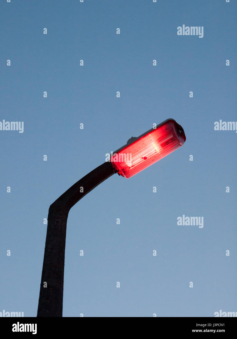 red street light outside turning on Stock Photo - Alamy