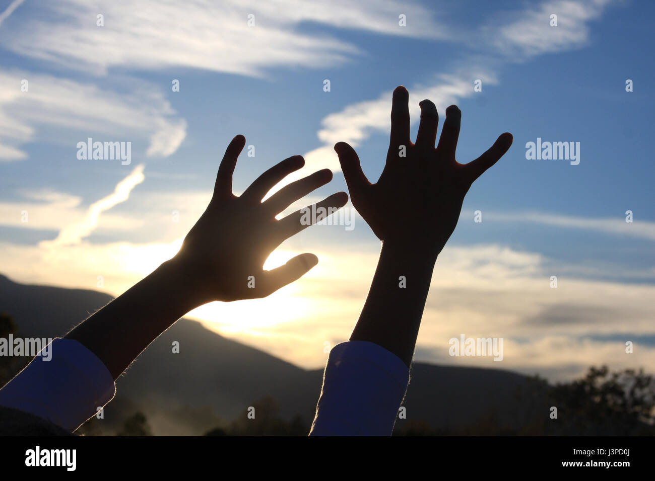 Girl's hands reaching for the sky Stock Photo - Alamy