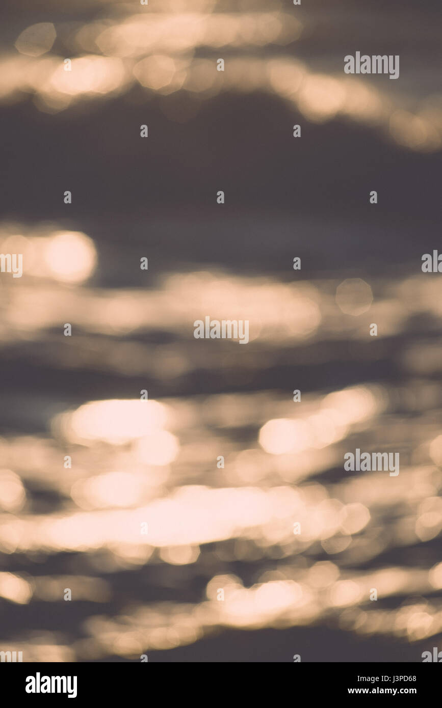 out of focus blur background with sea water in sunset light - retro ...