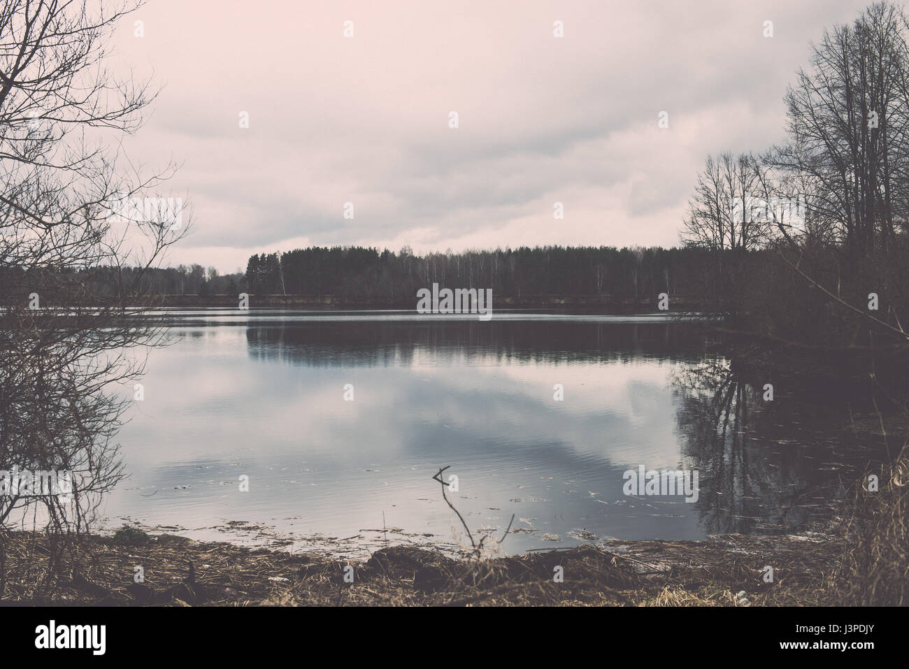 dramatic clouds over the river in misty morning in spring with ...