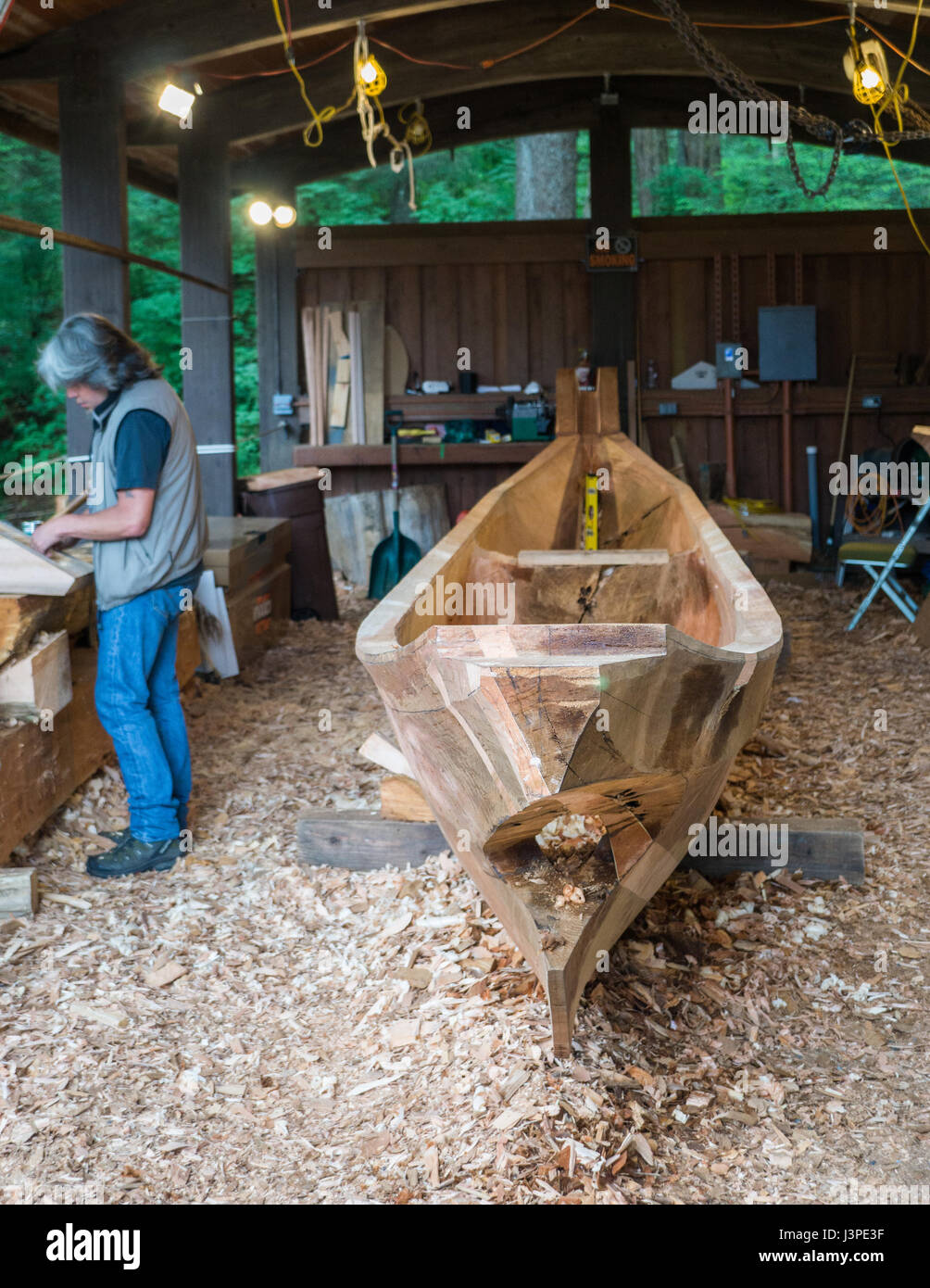 Artist carving a native canoe in Sitka, Alaska Stock Photo - Alamy