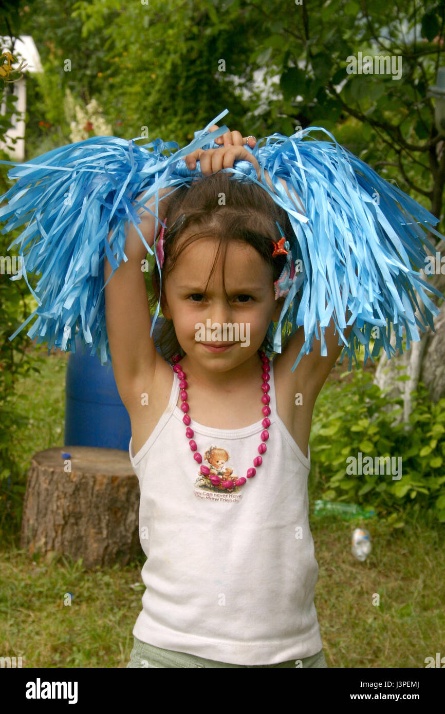 Little girl playing with pom poms Stock Photo - Alamy