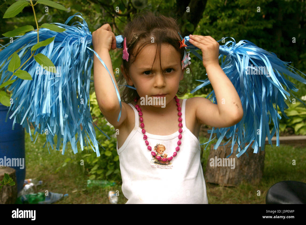 Little girl playing with pom poms Stock Photo - Alamy