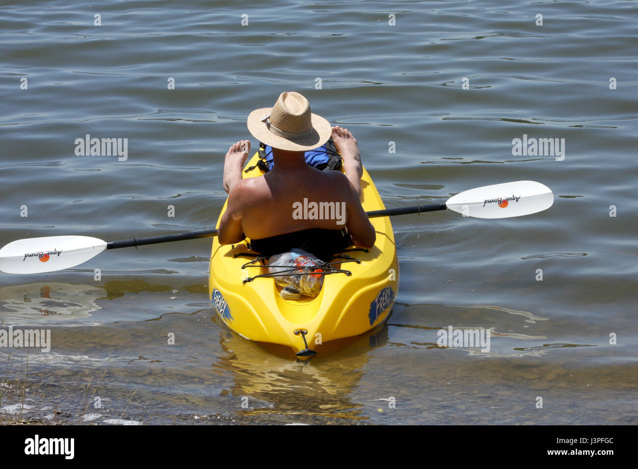 Man in kayak on shore Stock Photo - Alamy