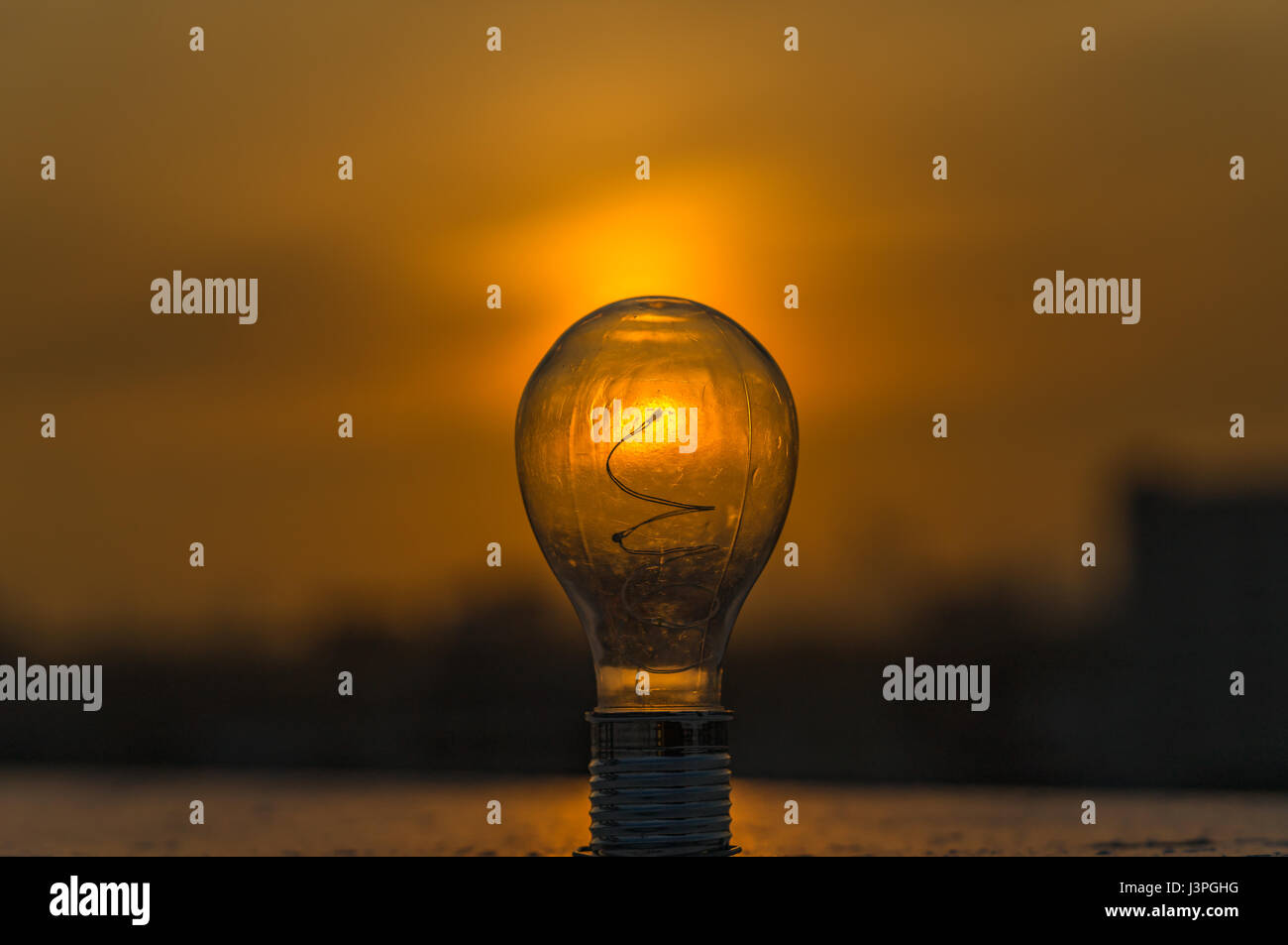 Bright idea concept, electric bulb and sunset Stock Photo - Alamy