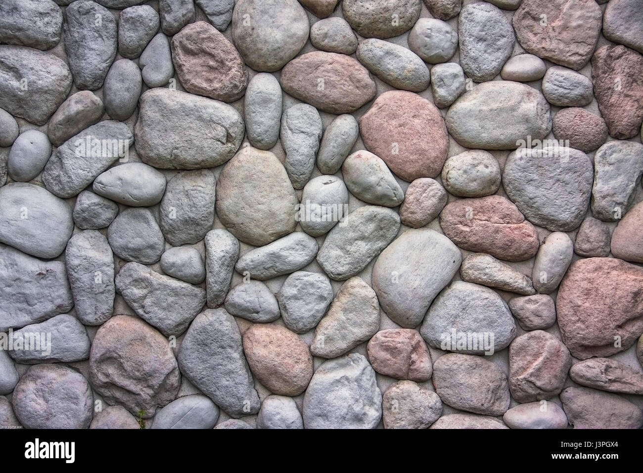 construction modern style of beautiful oval stone wall with cement ...