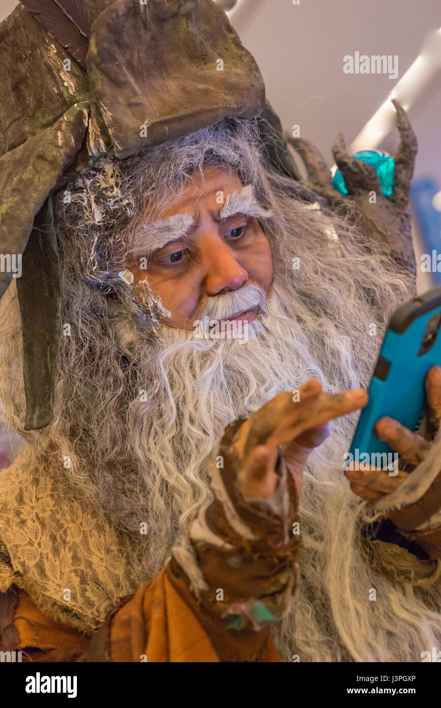 A very old man with a long beard playing with a smart phone Stock Photo ...