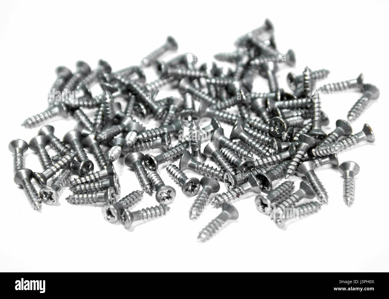 many short screws on white background Stock Photo - Alamy