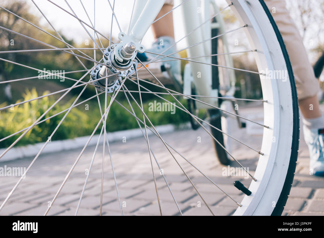 Closeup of bike wheel with chrome spokes and white tires Stock Photo ...