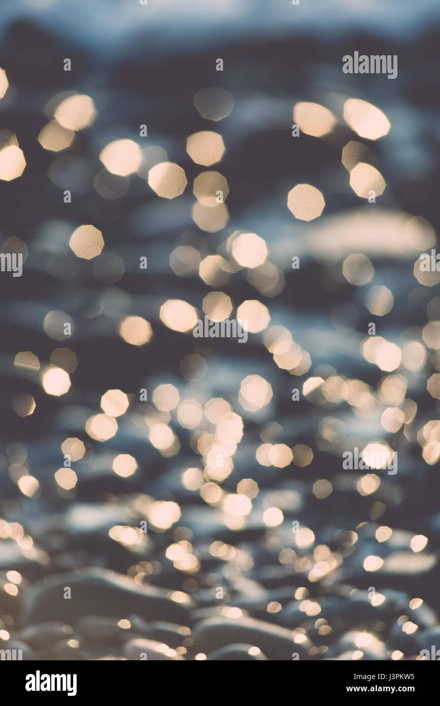 out of focus blur background with sea water in sunset light - retro ...