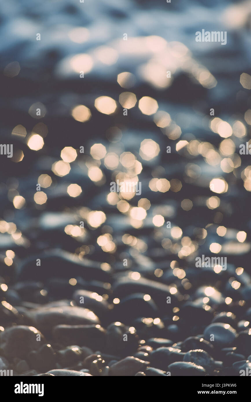 out of focus blur background with sea water in sunset light - retro ...